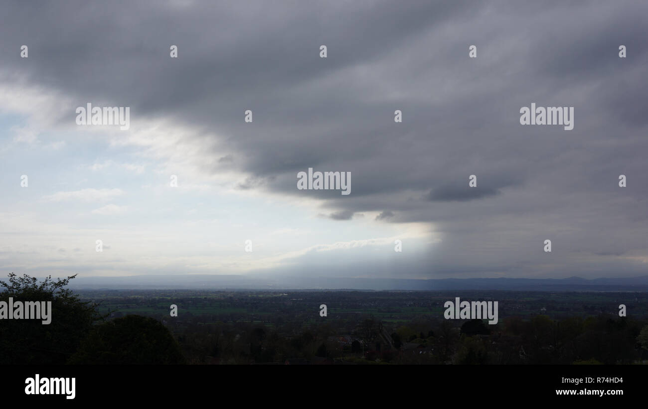 Curved cloud dominates the landscape while the dark underexposed ...