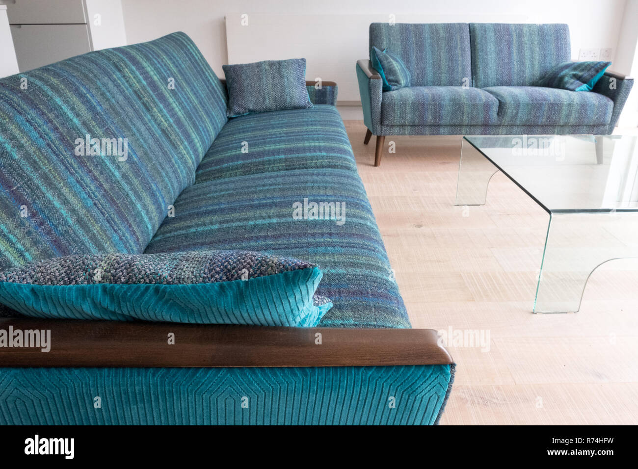 Two retro style lounge sofas upholstered in blue / green striped wool ...