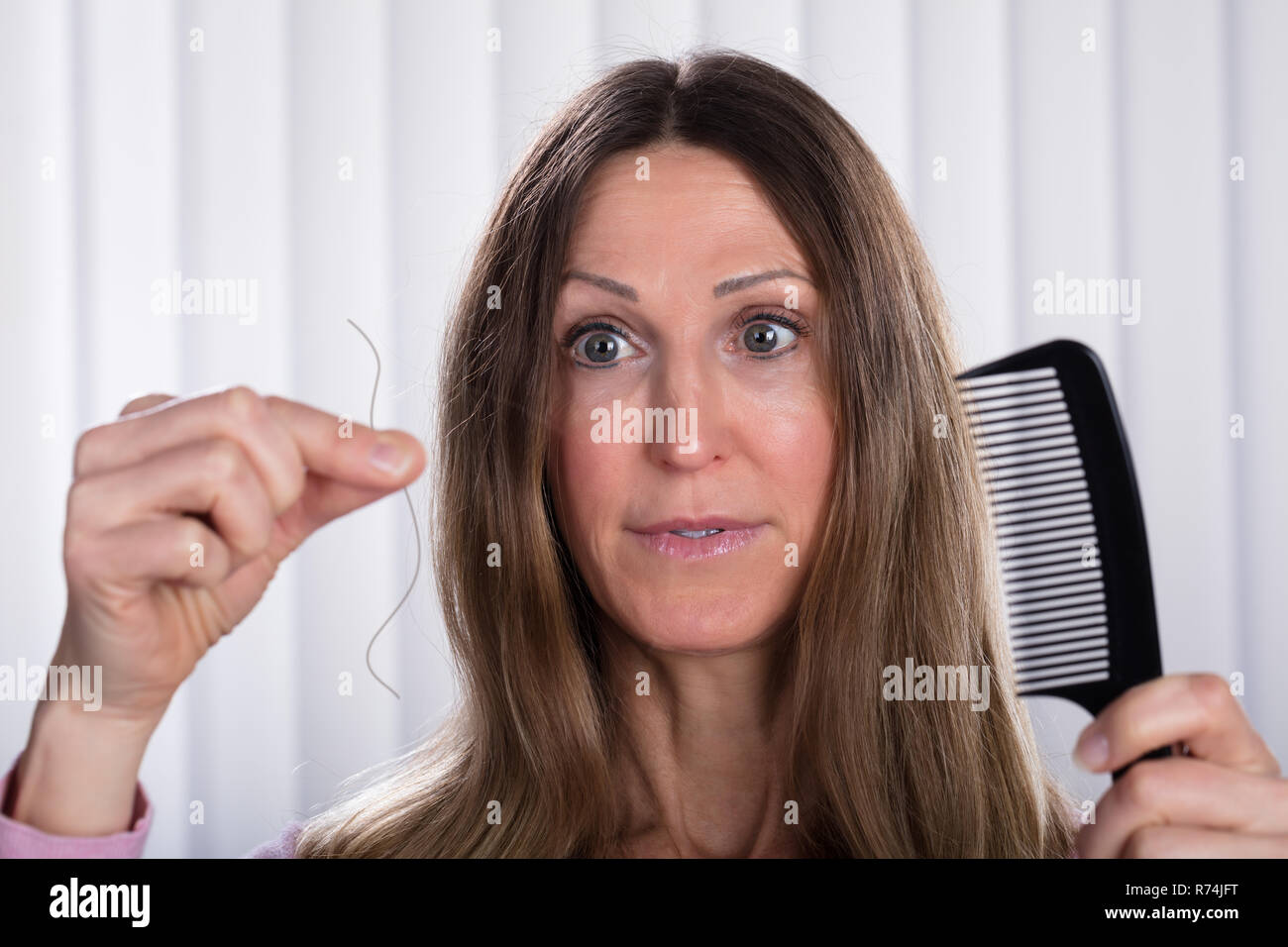 Shocked Woman Losing Hair Stock Photo - Alamy