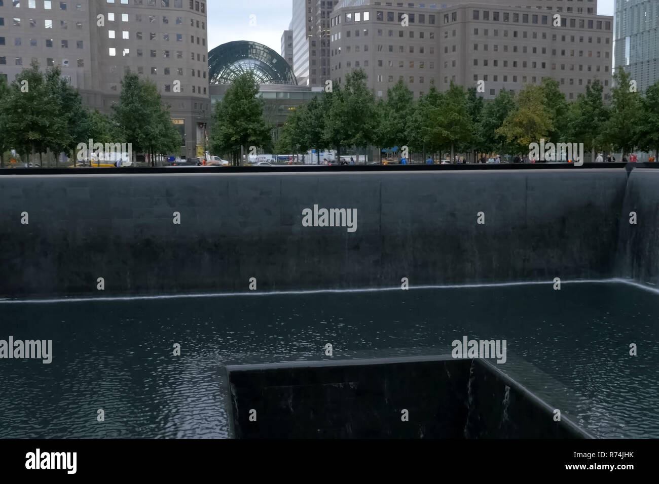 Fountain with a waterfall. Walking through the streets of New York ...