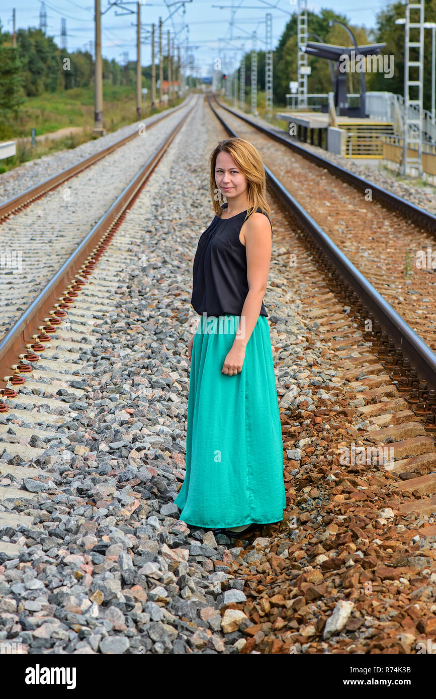 Standing girl between two railway path Stock Photo - Alamy
