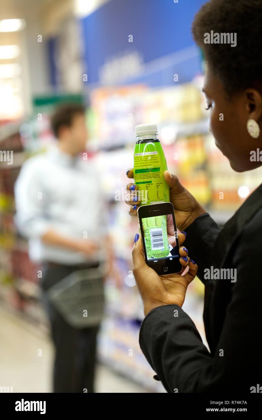 Shopping using a smart phone to scan barcodes of consumer goods in a ...