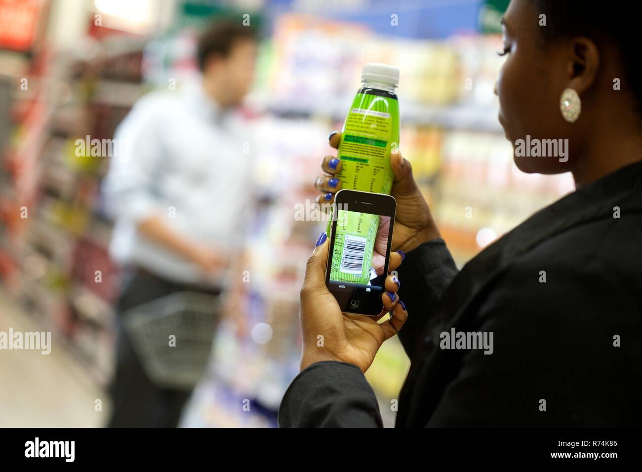 Shopping using a smart phone to scan barcodes of consumer goods in a ...