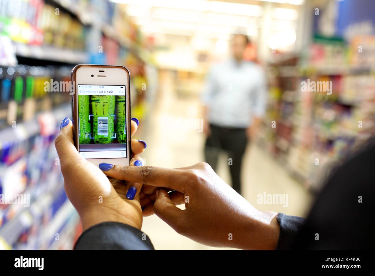 Shopping using a smart phone to scan barcodes of consumer goods in a ...