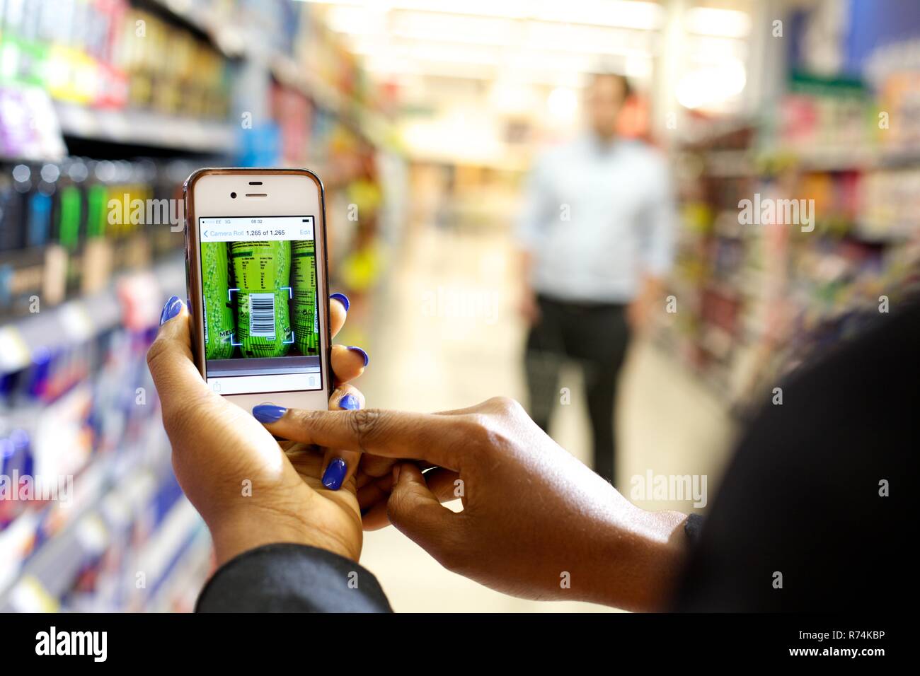 Shopping using a smart phone to scan barcodes of consumer goods in a ...