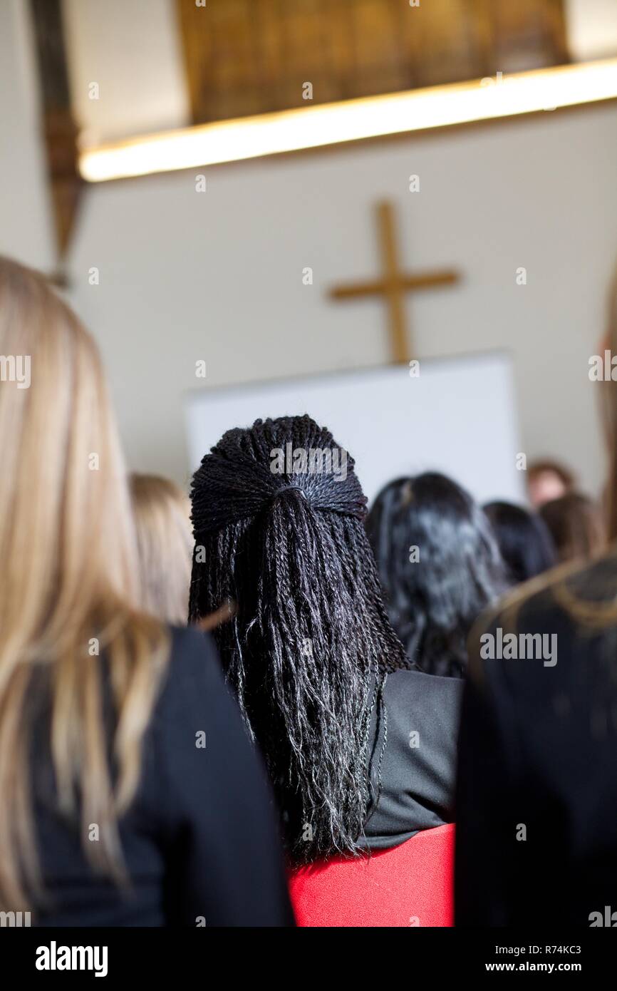 Girl with beautiful braided hair in a Catholic school assembly Stock ...