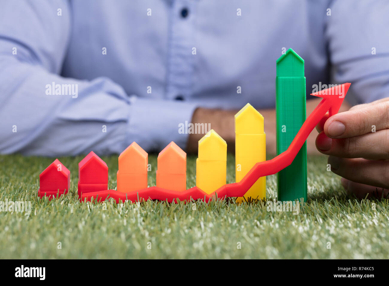 Person Holding Red Arrow In Front Of Increasing Graph Stock Photo - Alamy