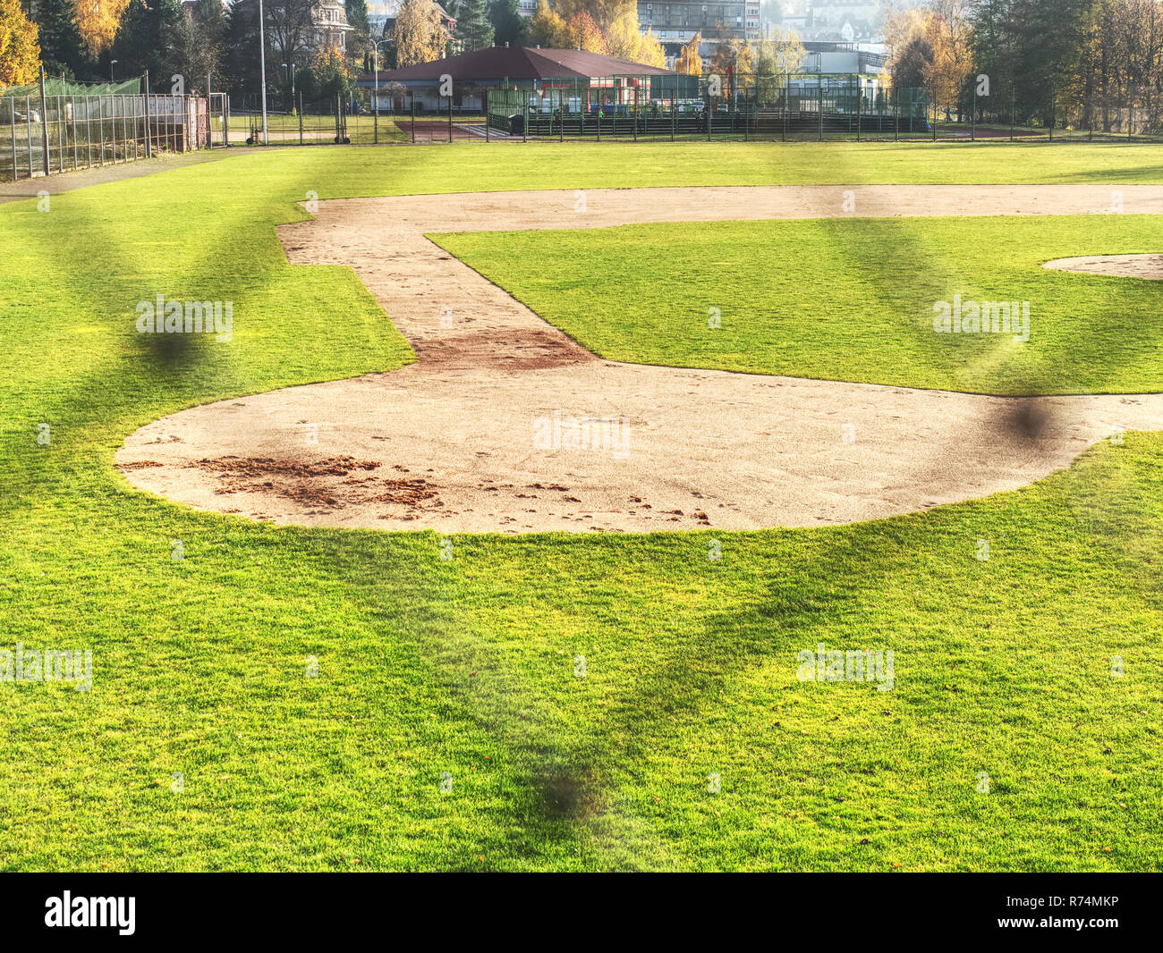 Baseball stadium. Green grass on baseball field behind of safety net ...