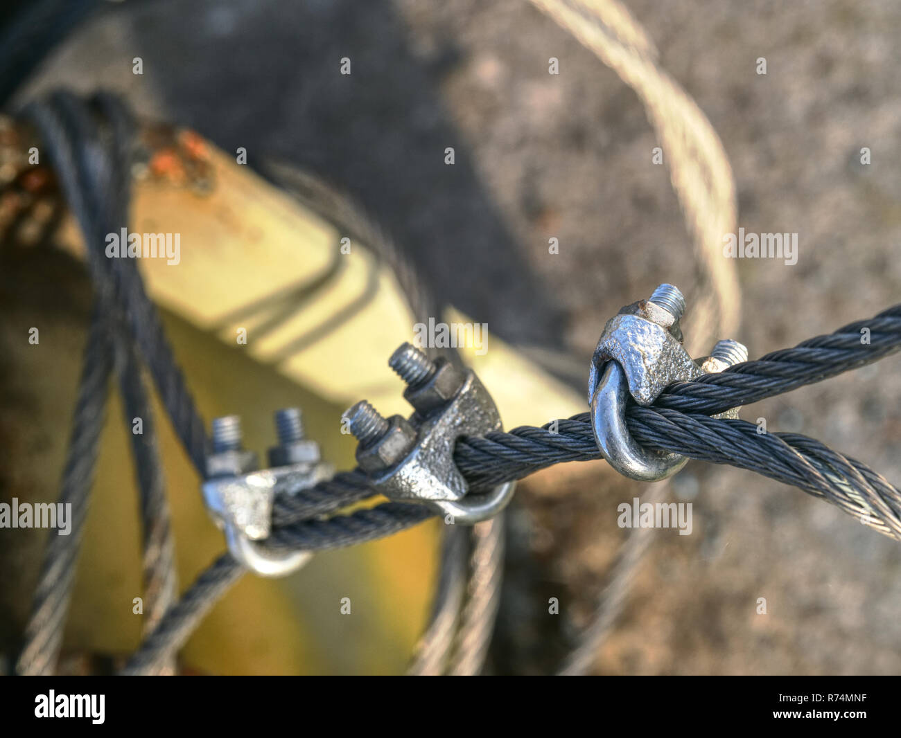 Shackles attached to wire cables and safety net. Stainless steel screw ...
