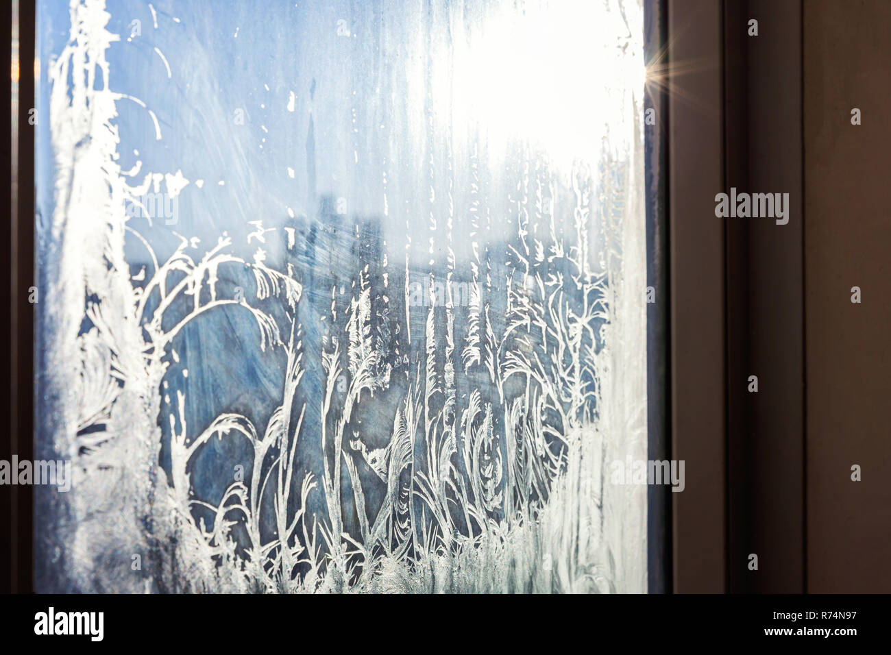 Frozen winter window with shiny ice frost pattern texture. Christmas ...