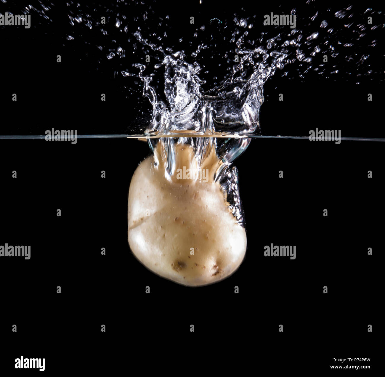 Potato splashing and sinking underwater. White beackgroung Stock Photo ...