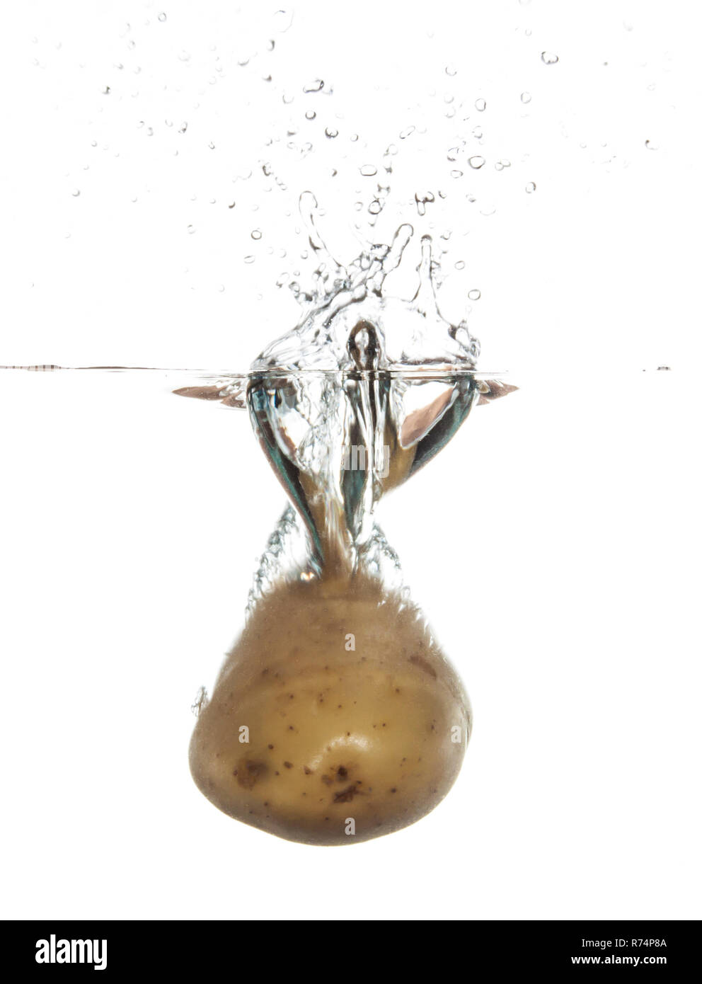 Potato splashing and sinking underwater. White beackgroung Stock Photo ...