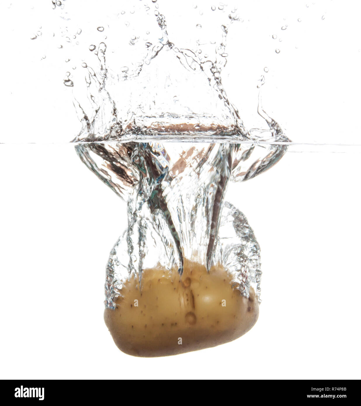 Potato splashing and sinking underwater. White beackgroung Stock Photo ...
