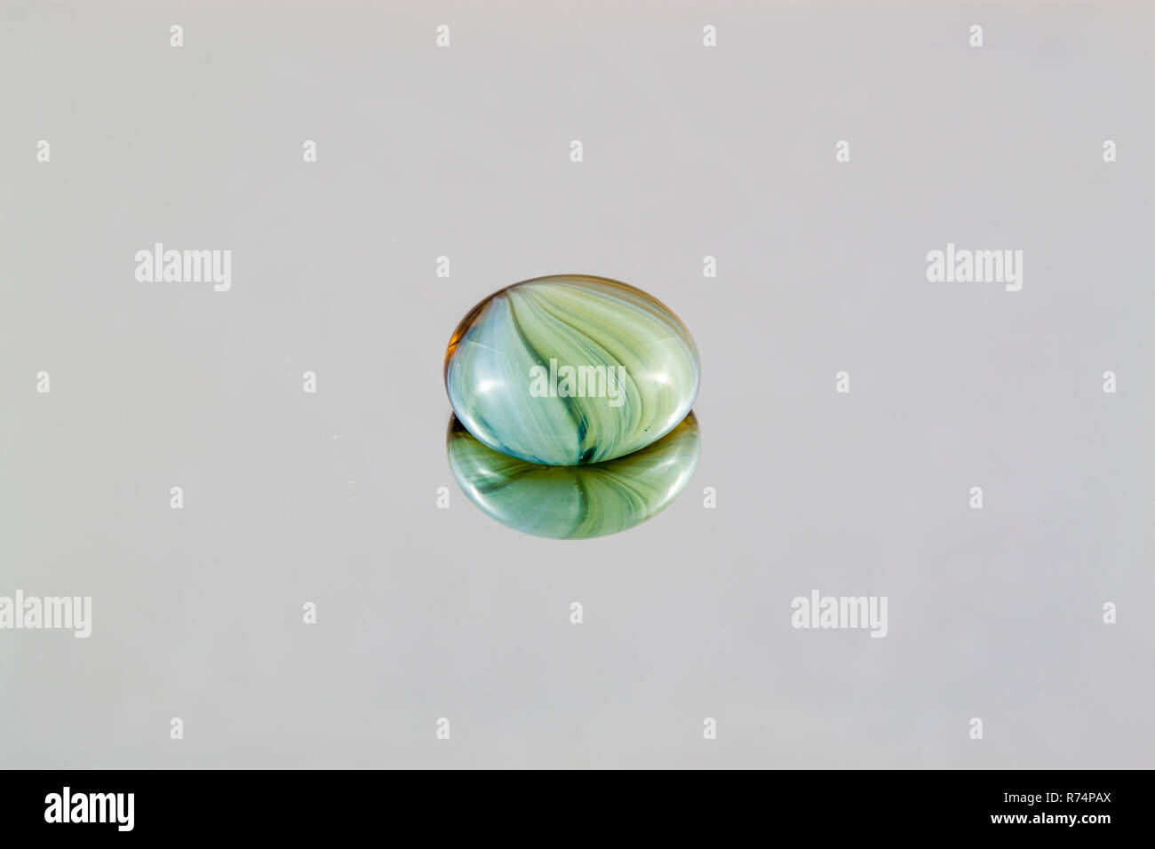Multi Colored gem on a reflective surface. Beautiful glasswork Stock ...