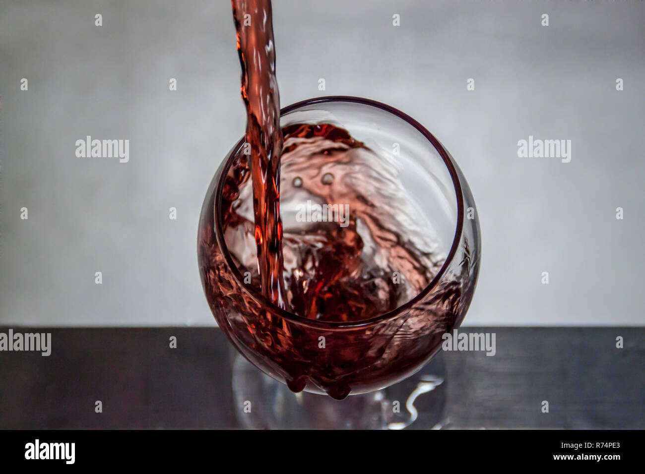 Interesting way for pouring and splashing wine in a glass Stock Photo ...