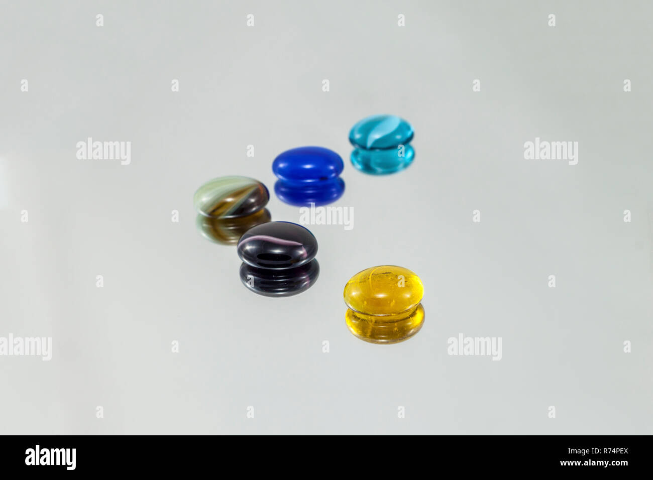 Decorative Gems arranged on a reflective surface Stock Photo - Alamy