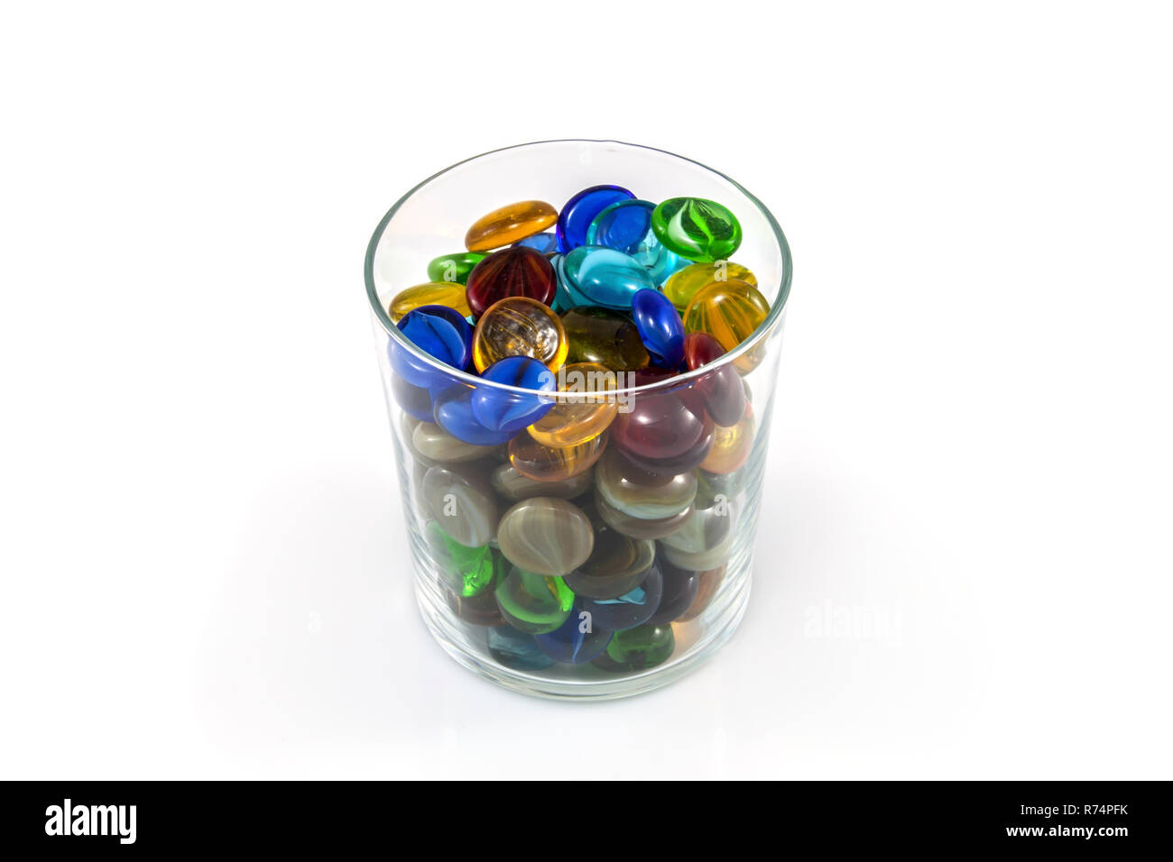 Glass filled with decorative gems Stock Photo - Alamy