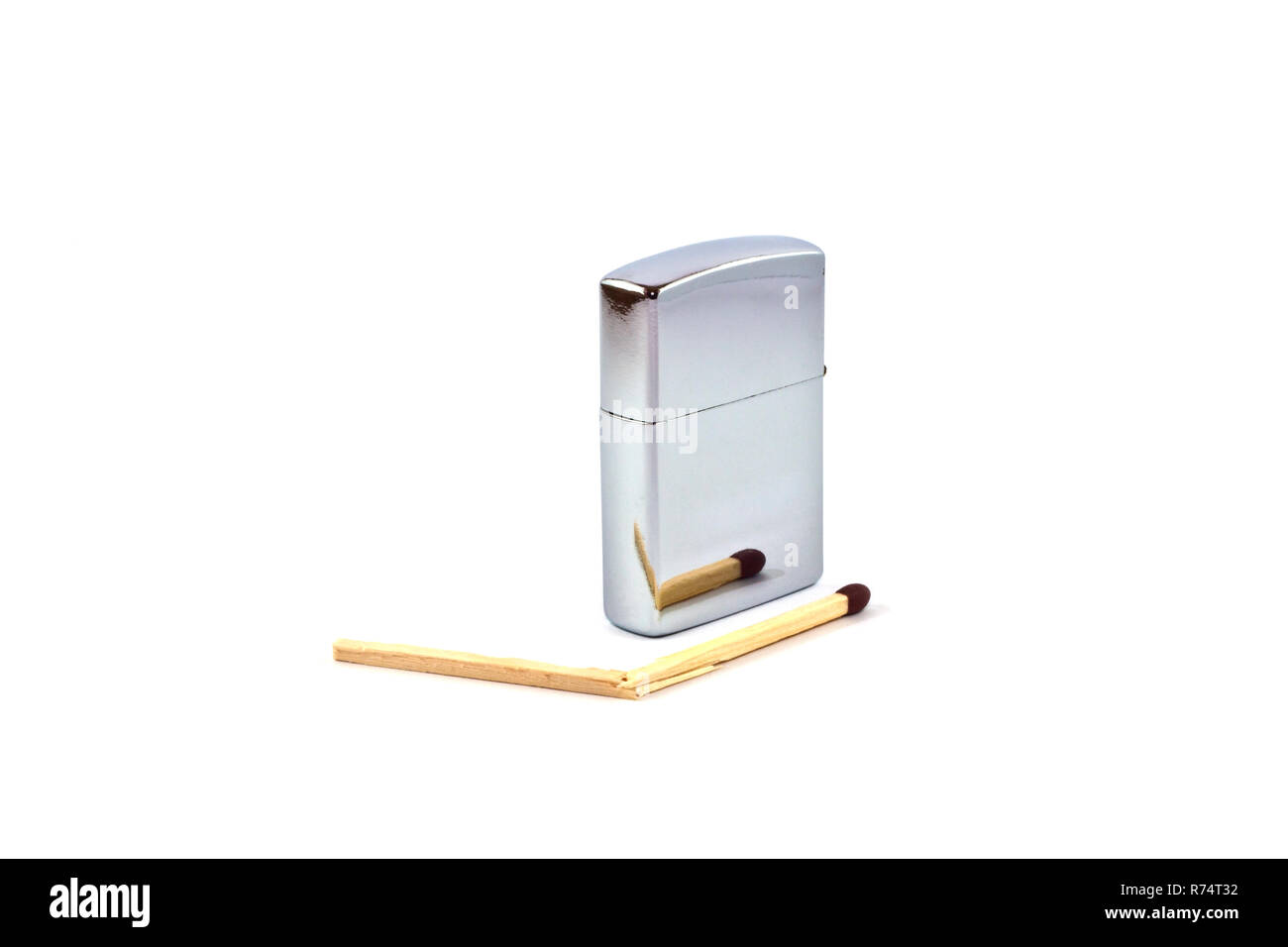 Broken match lyingin front of a shiny lighter Stock Photo - Alamy