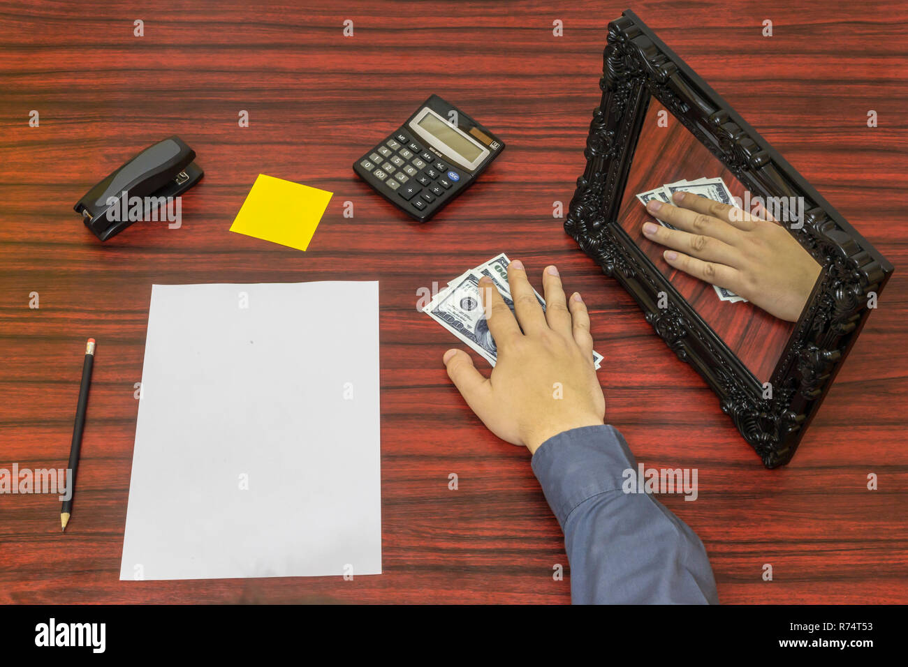 Hand taking money in front of a mirror Stock Photo - Alamy