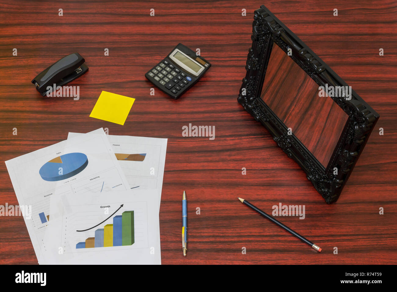 Sheet of paper with printed graphs on a desk with pen, pencil and ...