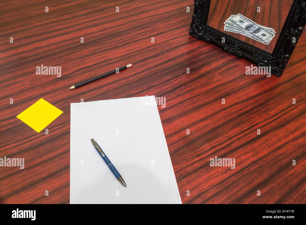 Reflection of money in the mirror. Both objects are surrounded by a ...