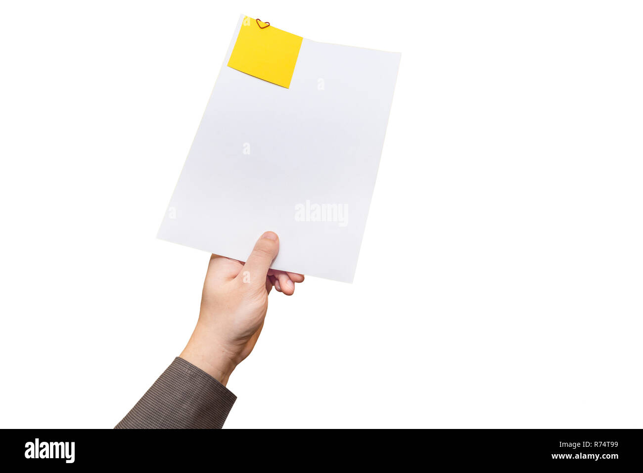 Human hand holding a sheet of paper with a yellow note on it. The note ...