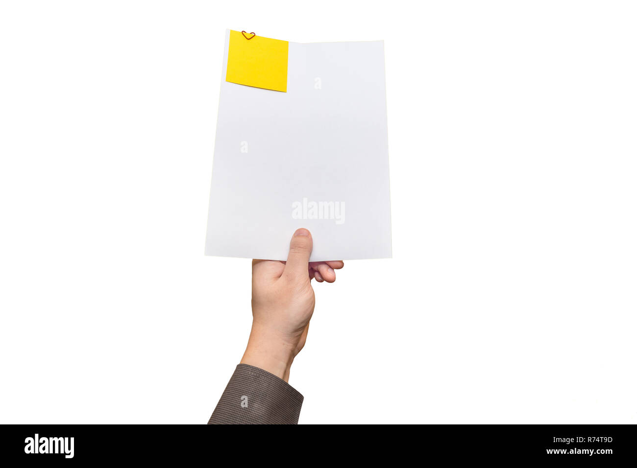 Human hand holding a sheet of paper with a yellow note on it. The note ...