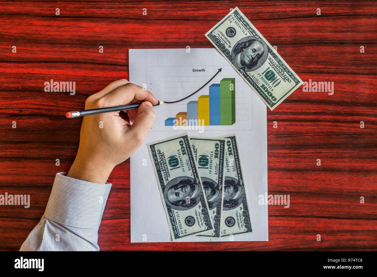 Left handed person analyzing charts Stock Photo - Alamy