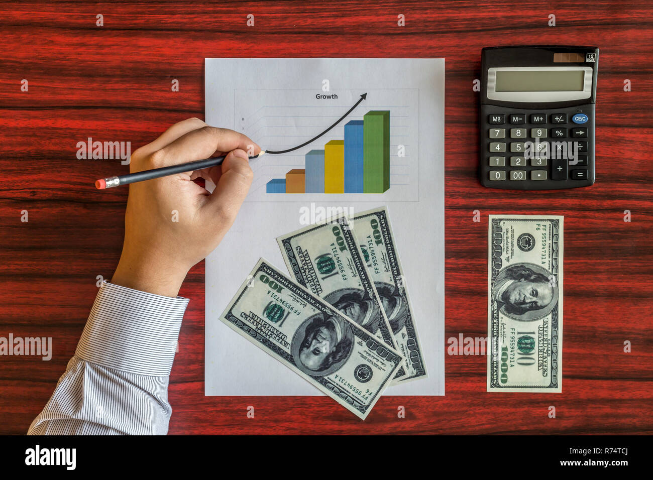 Left handed person analyzing charts Stock Photo - Alamy