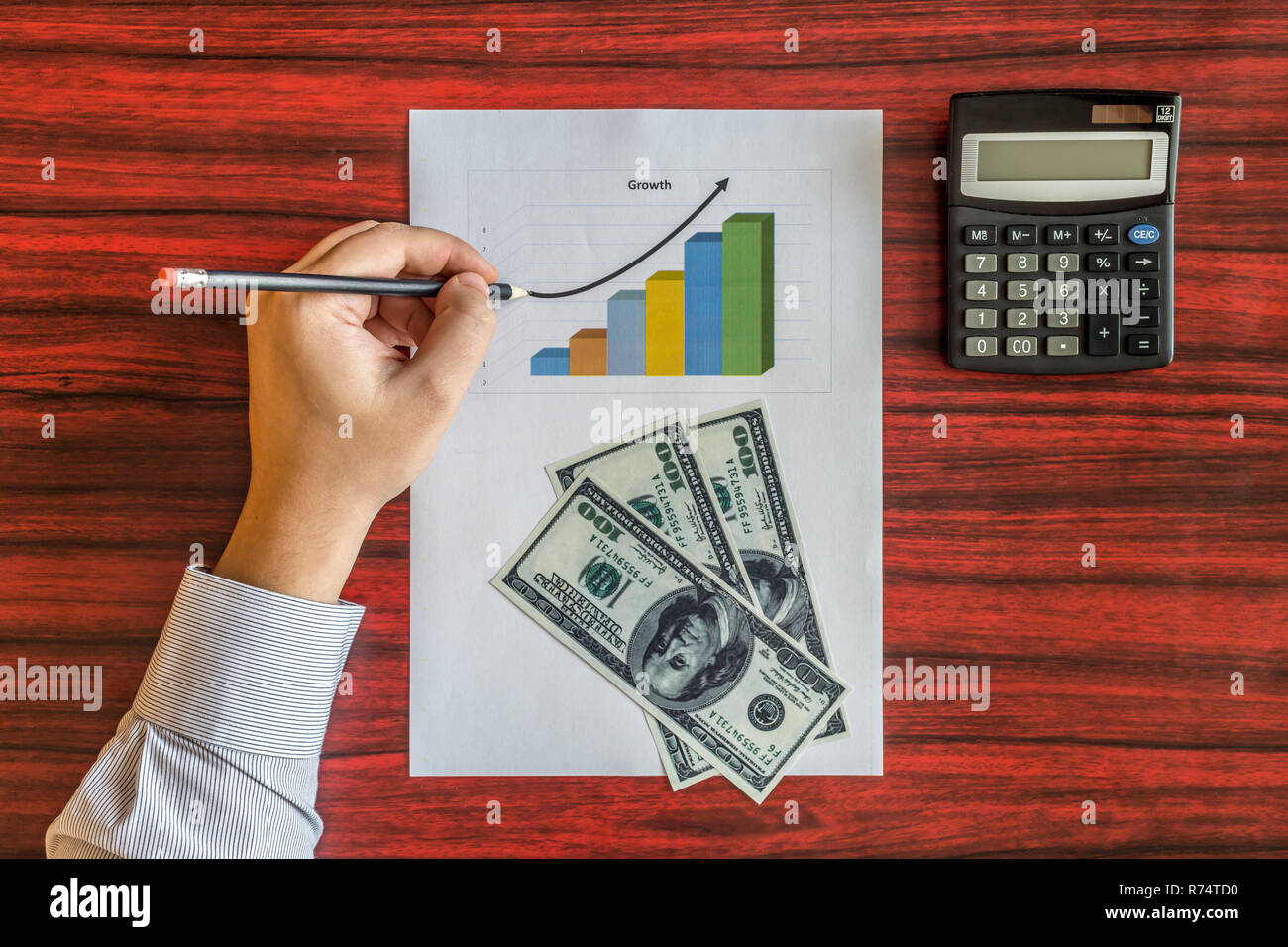 Left handed person analyzing charts Stock Photo - Alamy