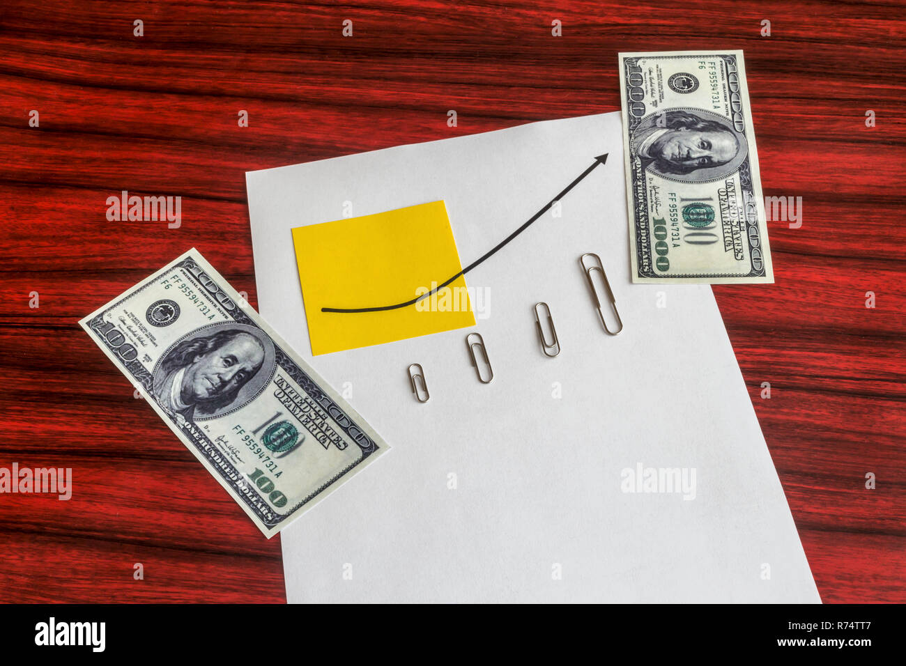 Curve graph printed on a sheet of paper and yellow note with arranged ...