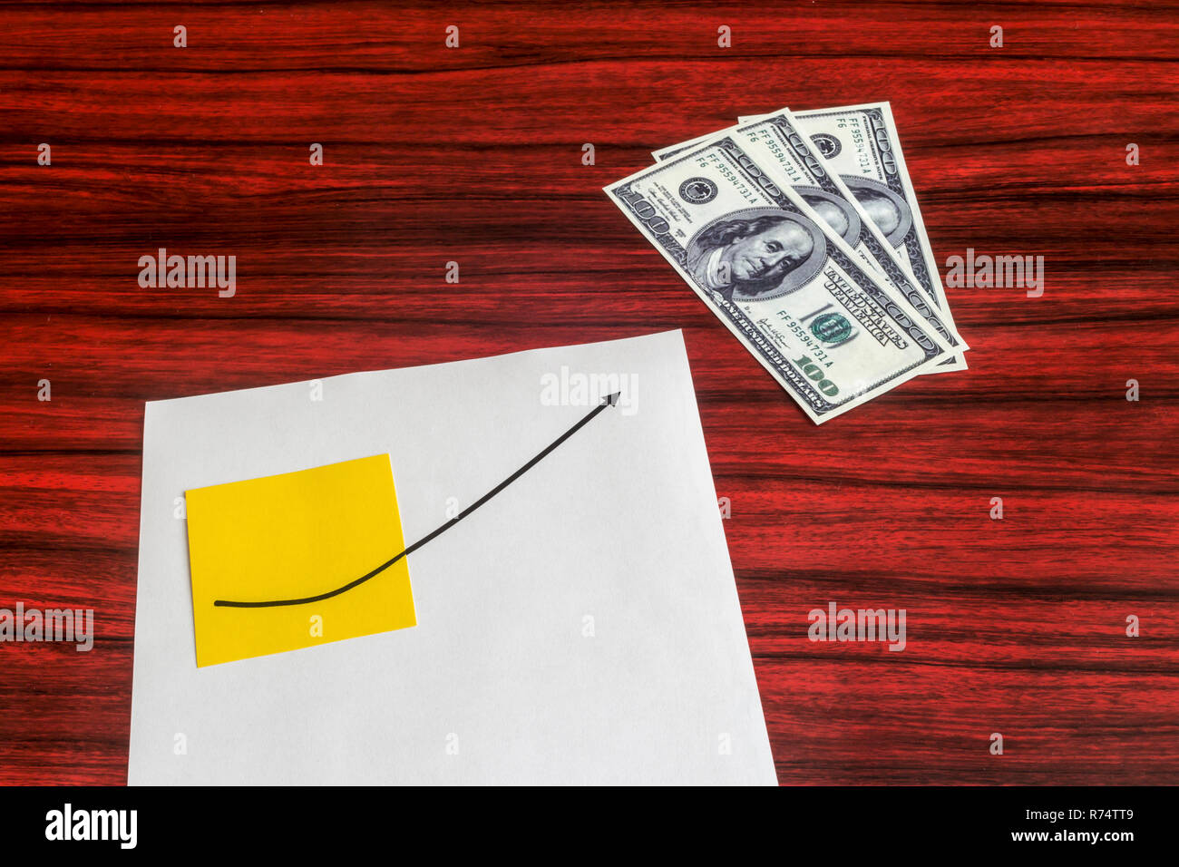 Curve graph printed on a sheet of paper and yellow note pointing a ...