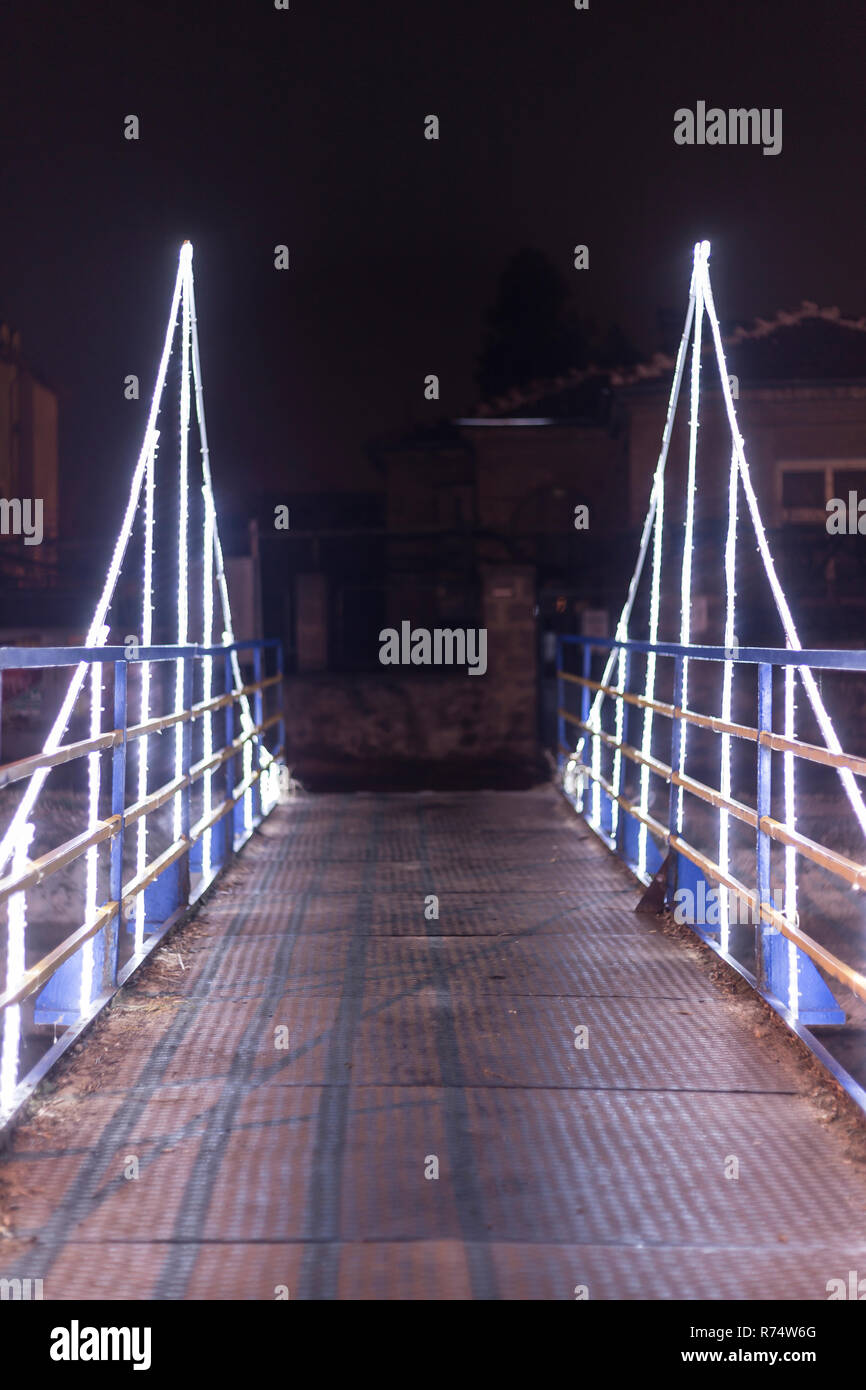 First person view of a pedestrian bridge decorated with Christmas ...
