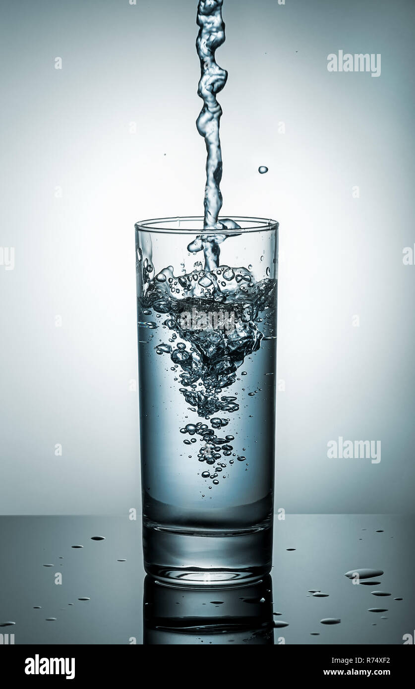 Water splashing from glass Stock Photo - Alamy