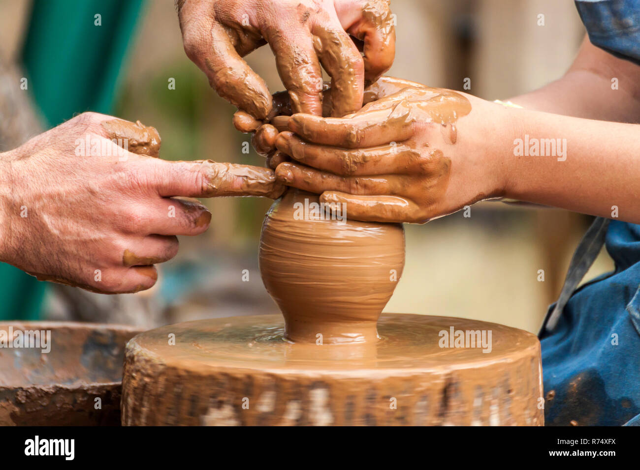 Pottery craftsman teaching people how to make pots Stock Photo - Alamy