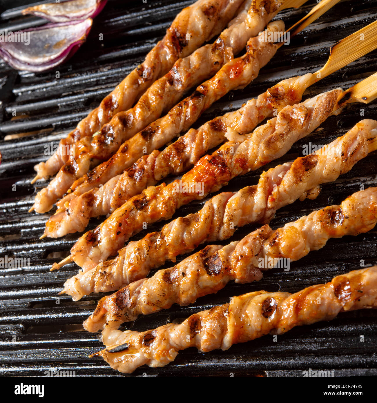 fresh and crispy rustic pork belly barbecue sticks Stock Photo - Alamy