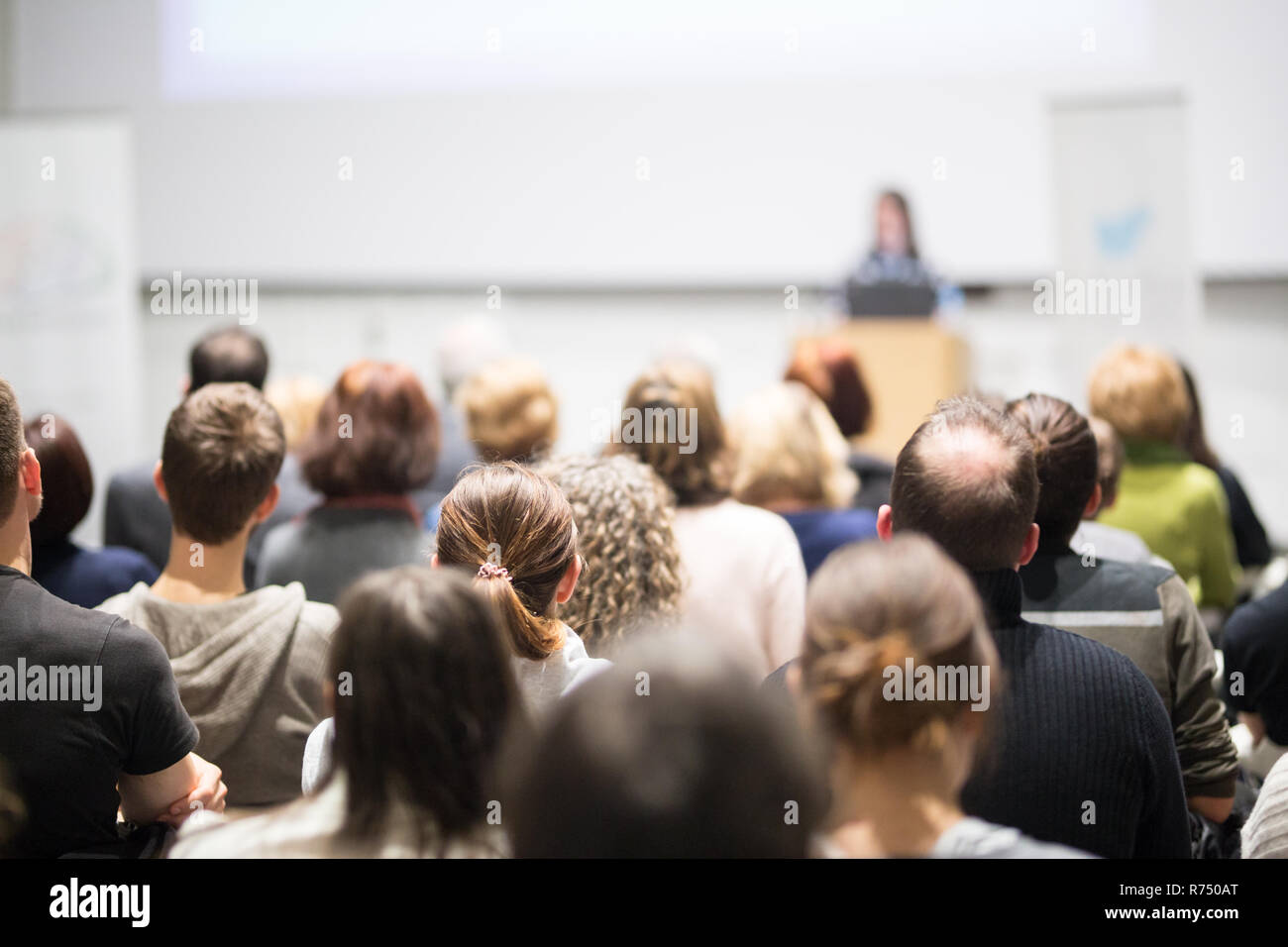 Woman giving presentation in lecture hall at university Stock Photo - Alamy