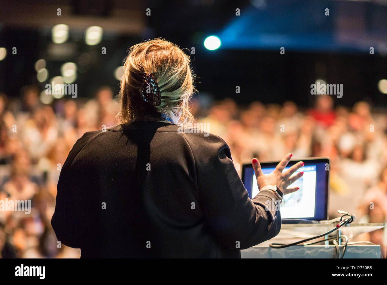 Female public speaker giving talk at Business Event Stock Photo - Alamy
