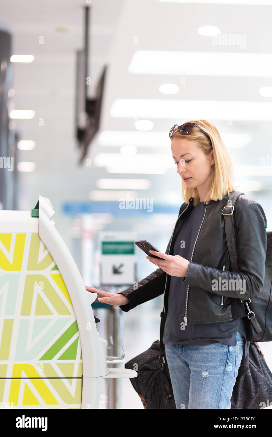 Casual caucasian woman using smart phone application and check-in ...