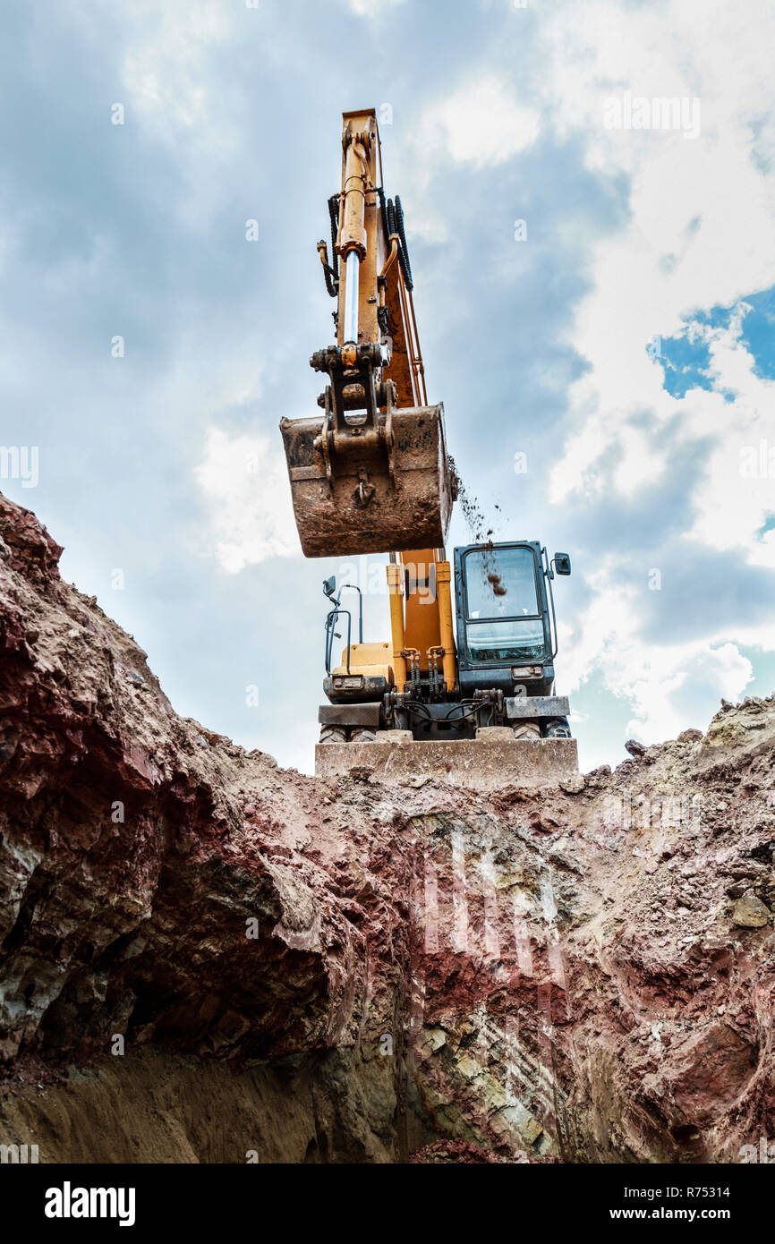 Excavator digging a trench for the pipeline. Excavation Stock Photo - Alamy