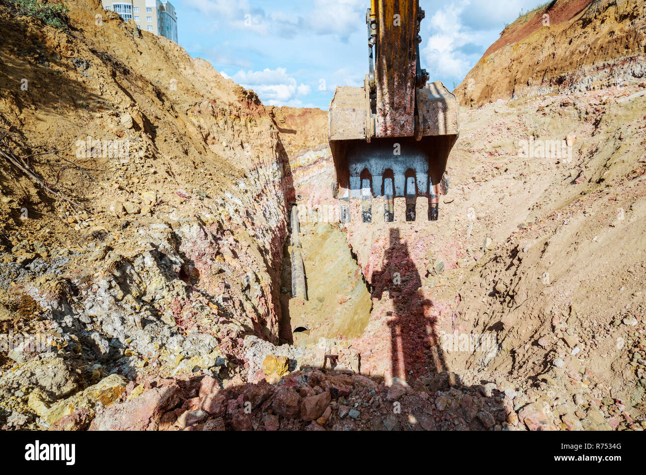 Excavator digging a trench for the pipeline. Bucket closeup Stock Photo ...