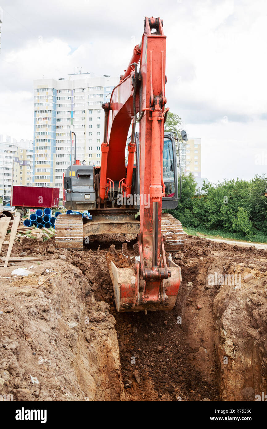 Excavator working on a construction site. Digging the trench for the ...
