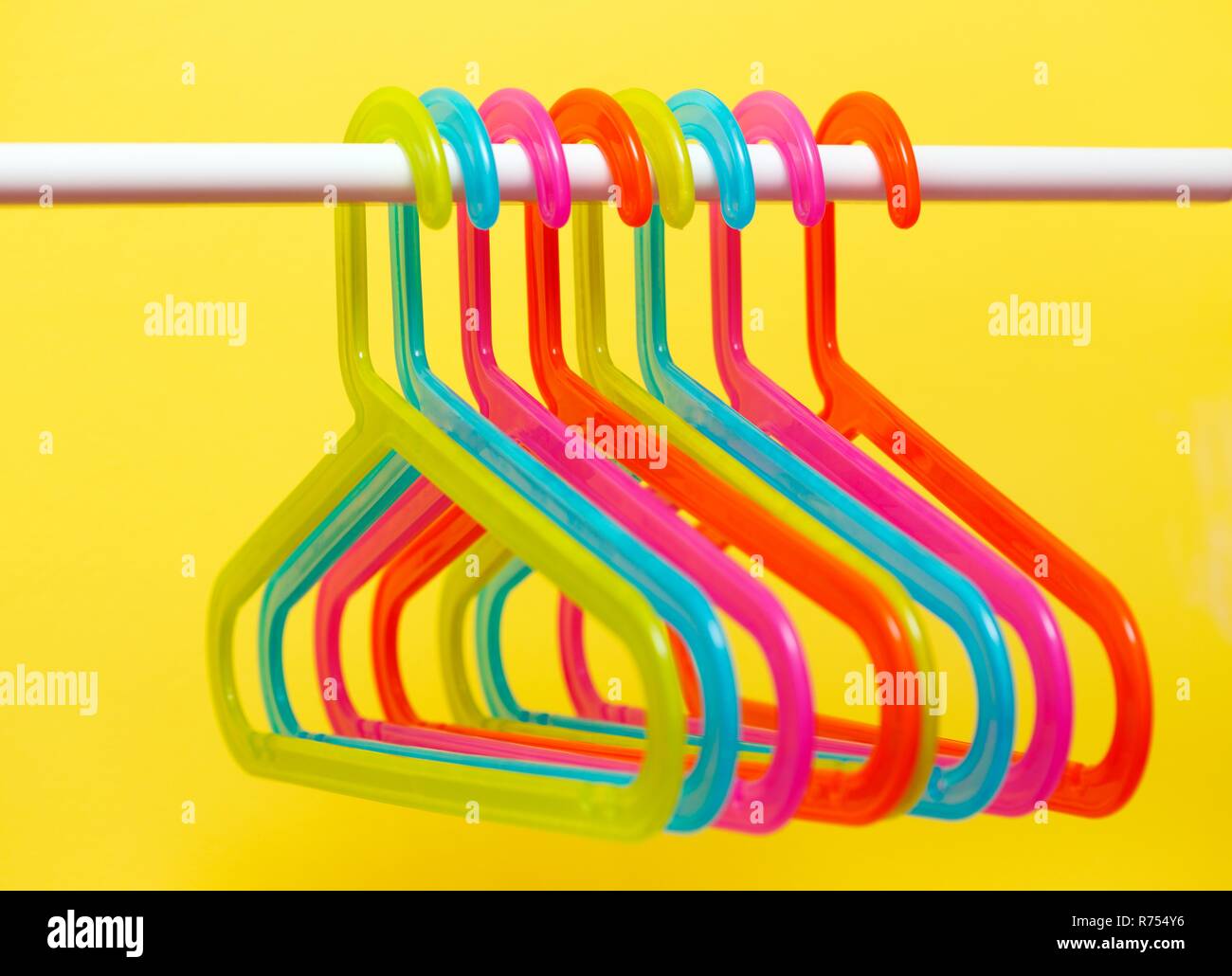 multicolored hangers on white background with small depth of field ...