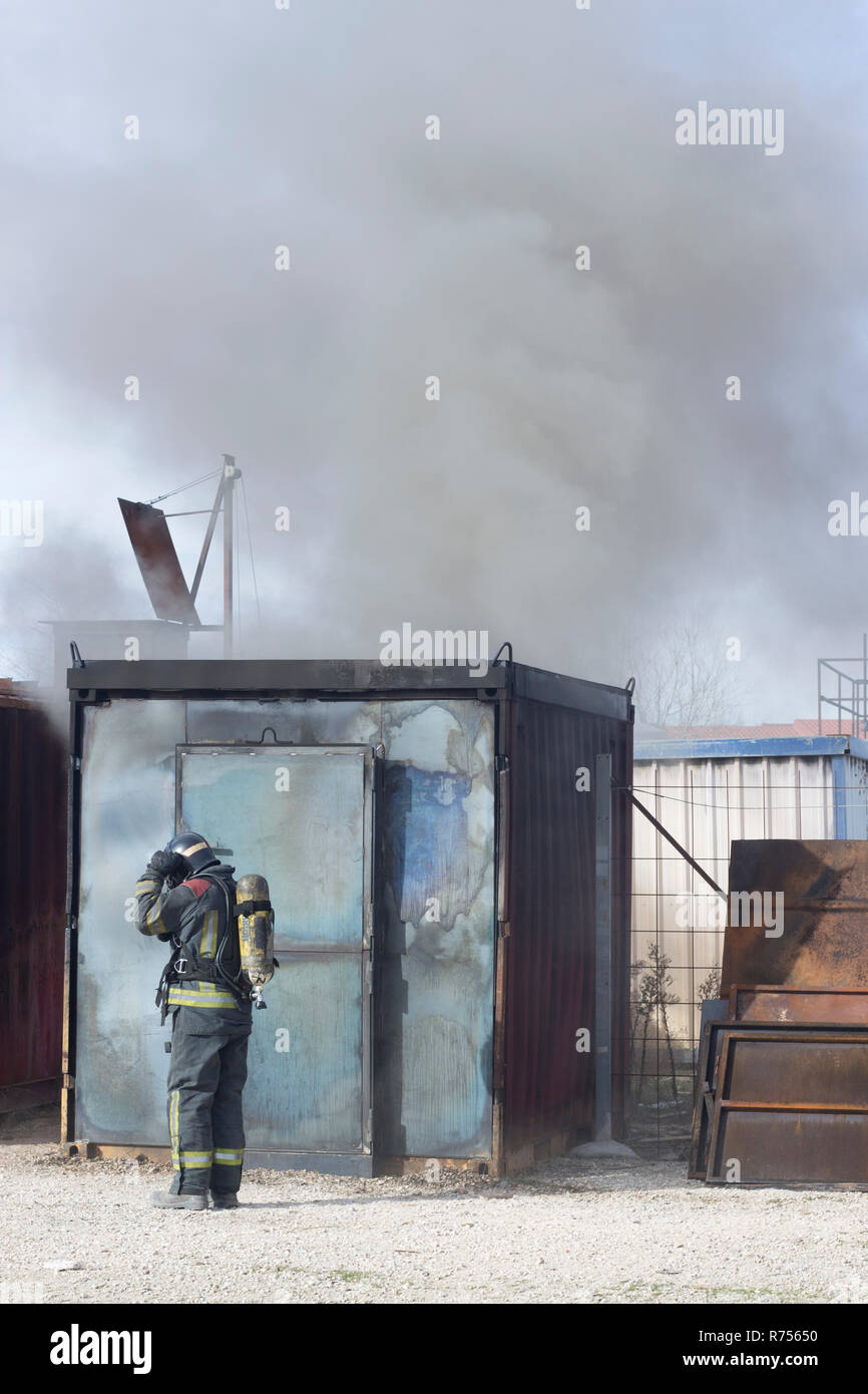 Firefighter putting out fire training station extinguisher backdraft ...