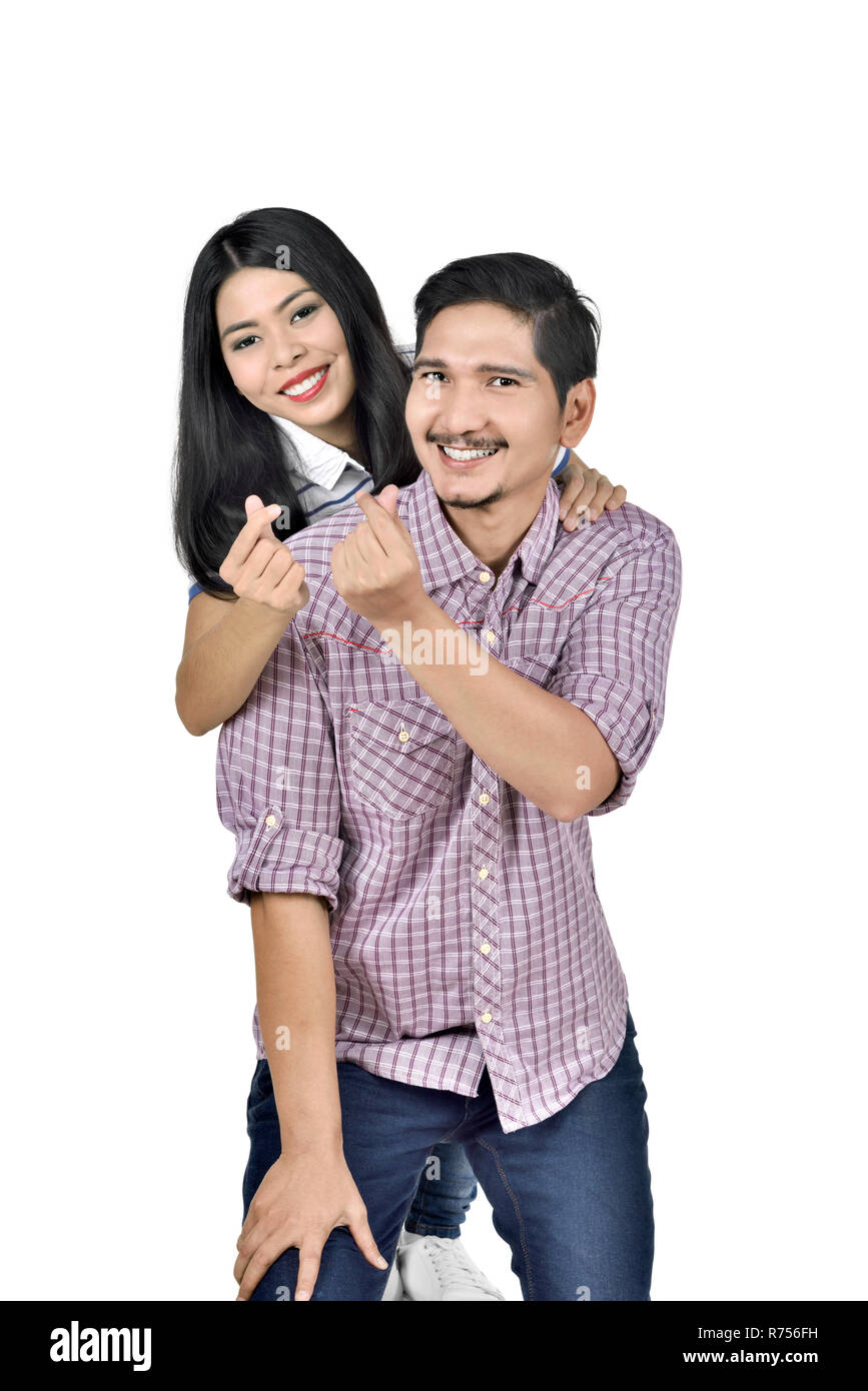 Portrait of asian man carrying the woman on his back with money gesture ...