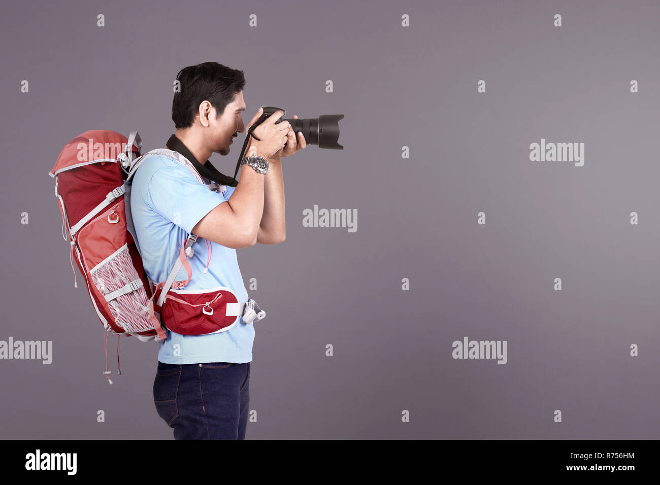 Handsome asian photographer man taking a photos with camera Stock Photo ...