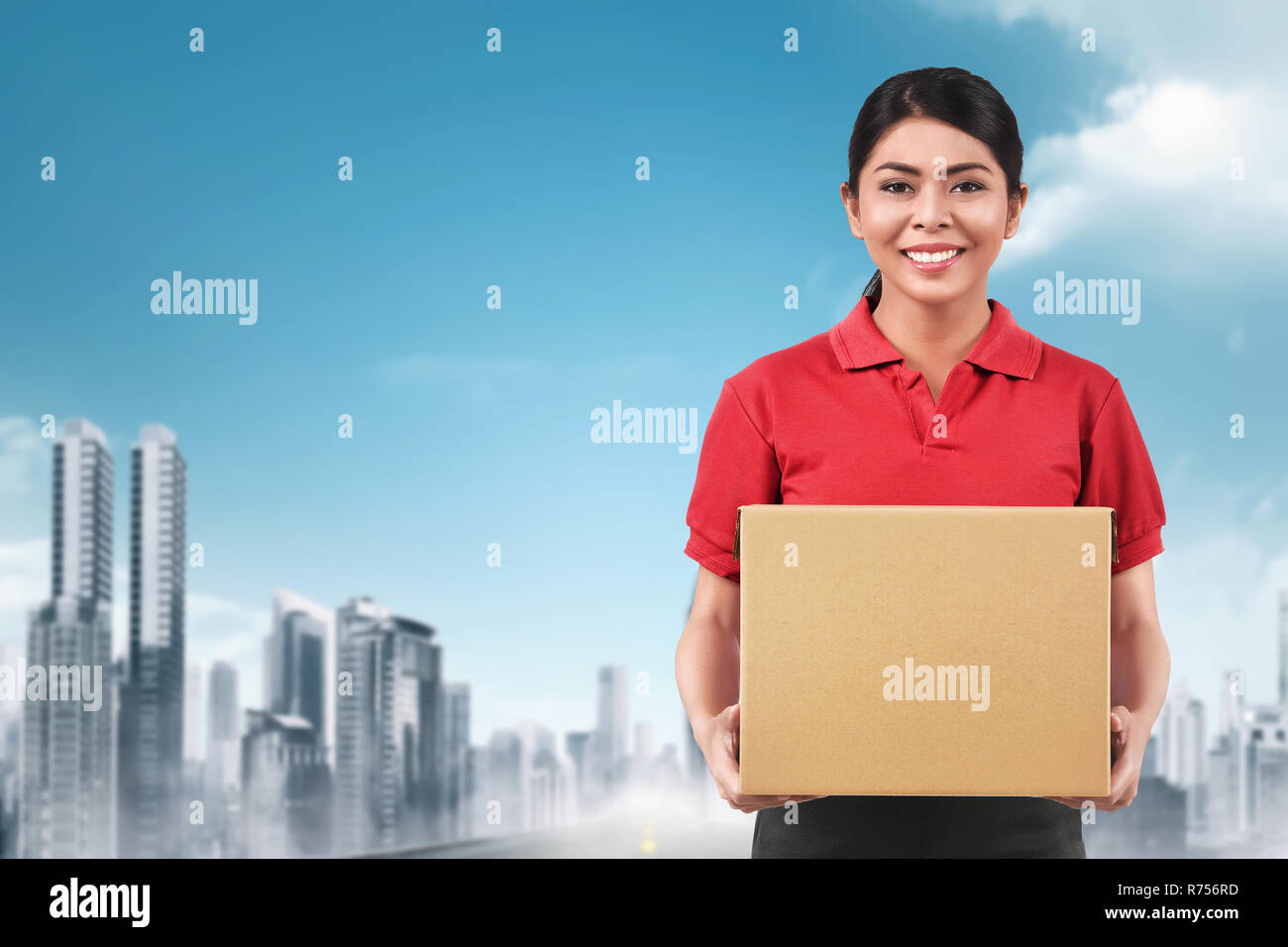 Beautiful asian delivery woman delivering parcel Stock Photo - Alamy