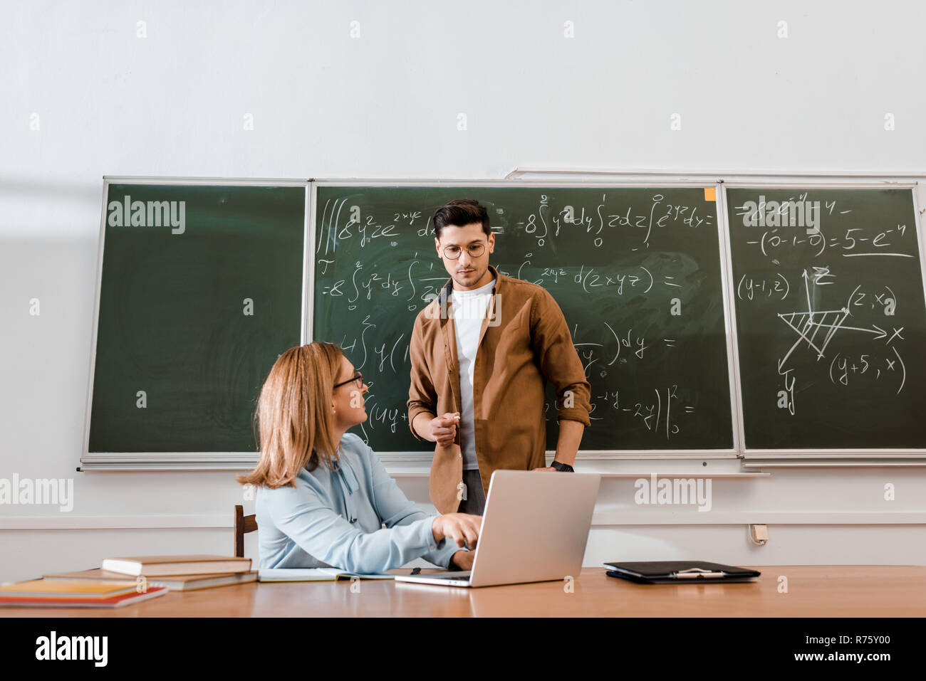 Caucasian teacher pointing laptop teaching hi-res stock photography and ...