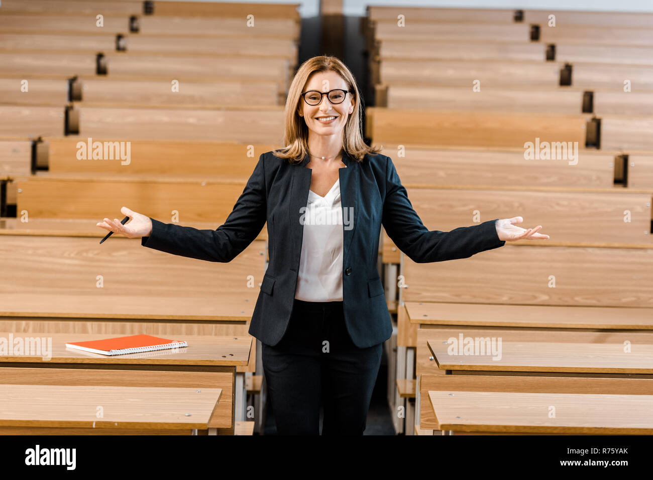 happy female university professor with outstretched hands looking at ...