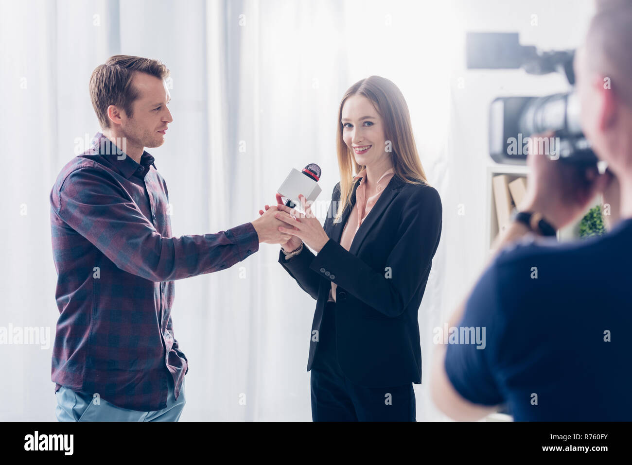 beautiful businesswoman in suit giving interview to journalist, holding ...